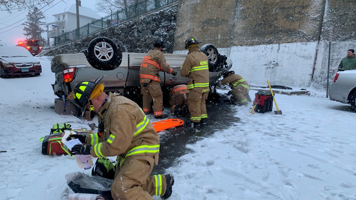 Firefighters Rescue Driver After Crash Through Fence, Onto Street Below ...