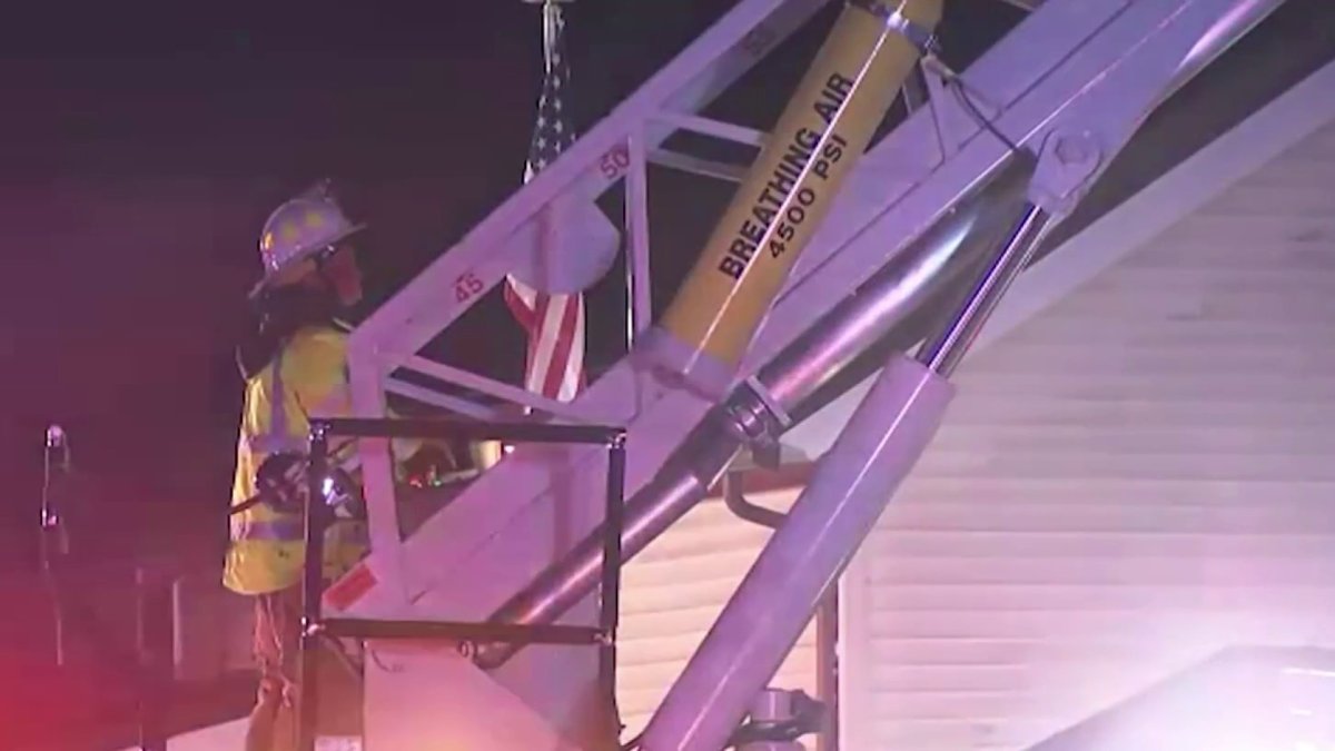 Power out for hundreds as crews battle hot spots after fire at vacant ...