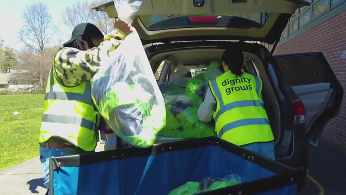 Dignity Grows hands out tote bags filled with feminine hygiene products ...