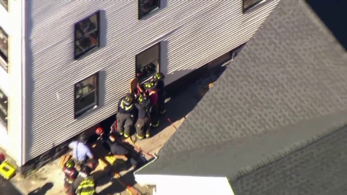 Worker rescued after being trapped under rocks in basement of ...